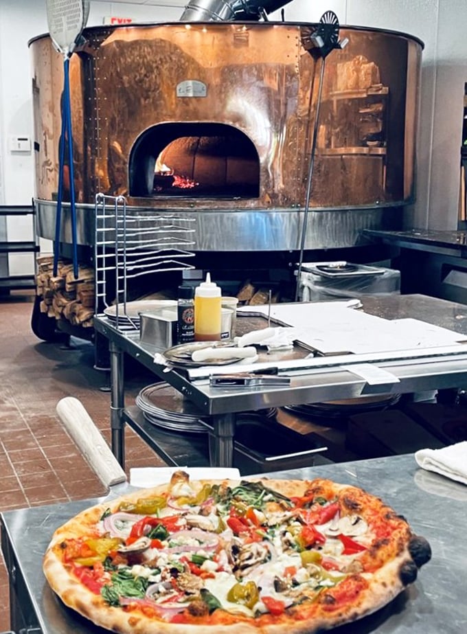 The magnificent copper oven isn't just equipment – it's the beating heart of Billy Bricks, radiating 800 degrees of pure culinary passion.