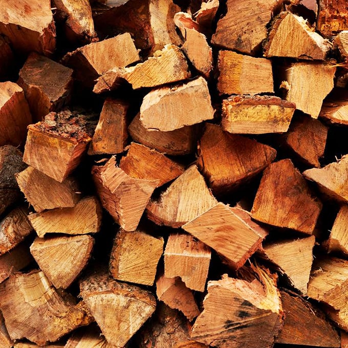 The secret ingredient isn't so secret – stacks of wood waiting to transform ordinary meat into extraordinary barbecue. Each piece contains future flavor.