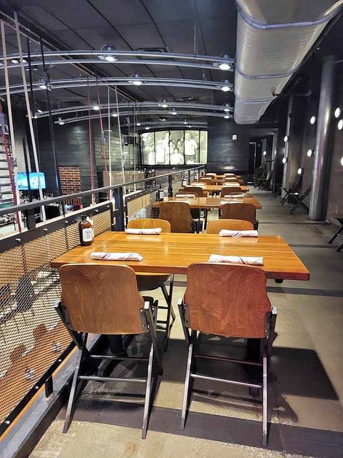 The second floor dining area offers industrial-cool vibes with a side of anticipation—each table set and ready for the parade of smoked delights about to arrive.