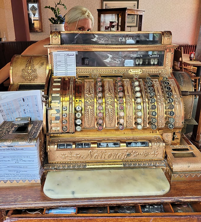 That antique cash register isn't just decoration—it's a brass-and-gold reminder that some things were simply built to last, including this cafe.
