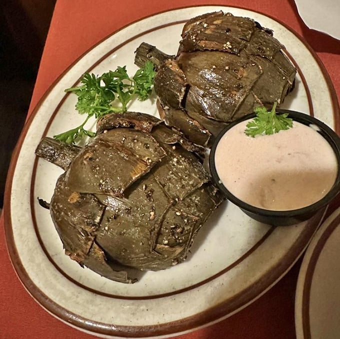 Artichokes transformed from armored vegetables into tender delicacies—proof that the Hitching Post's mastery extends beyond meat to everything that crosses their grill.
