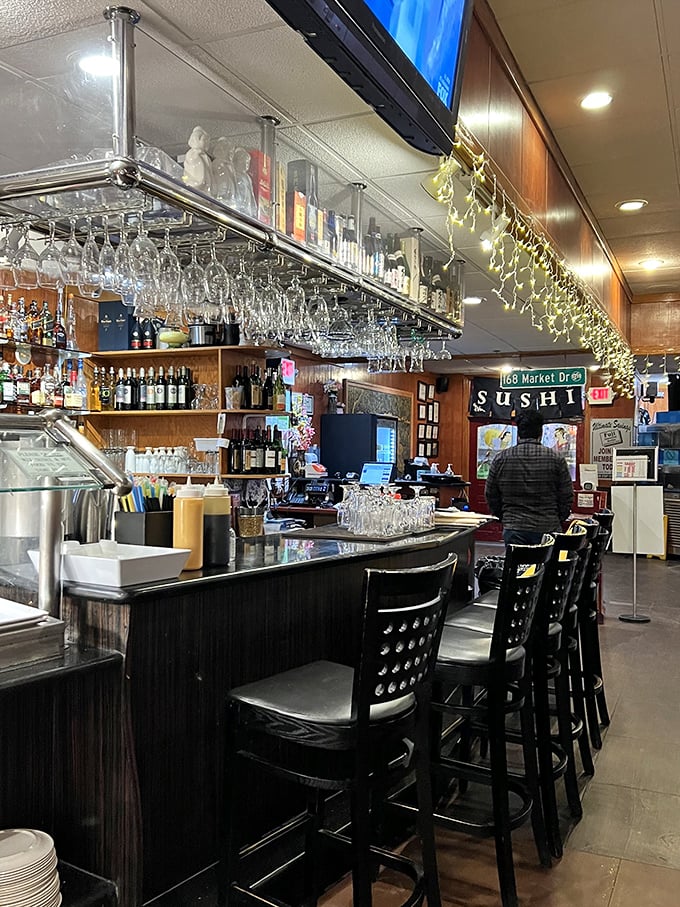 The full bar setup complete with hanging glassware, because sometimes great food deserves an equally great cocktail companion.
