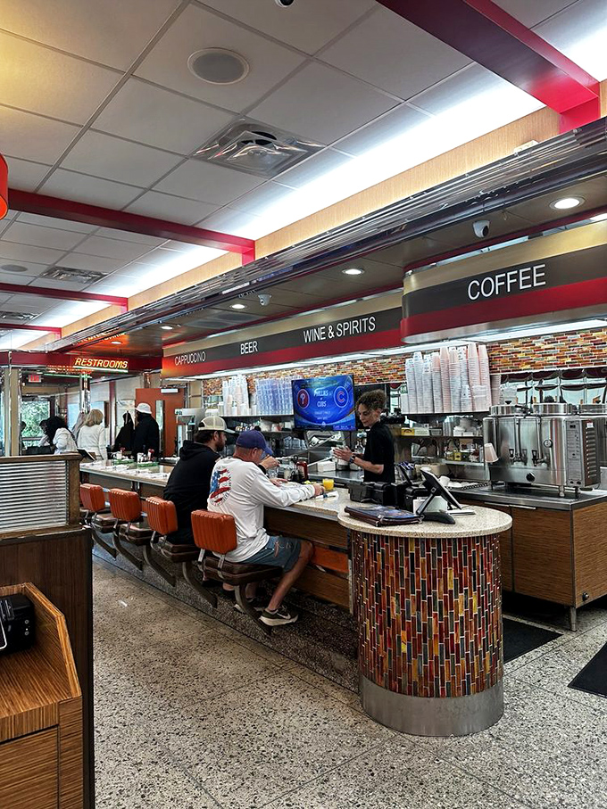 The counter seating—where solo diners become regulars, servers become friends, and coffee cups are never allowed to reach empty.