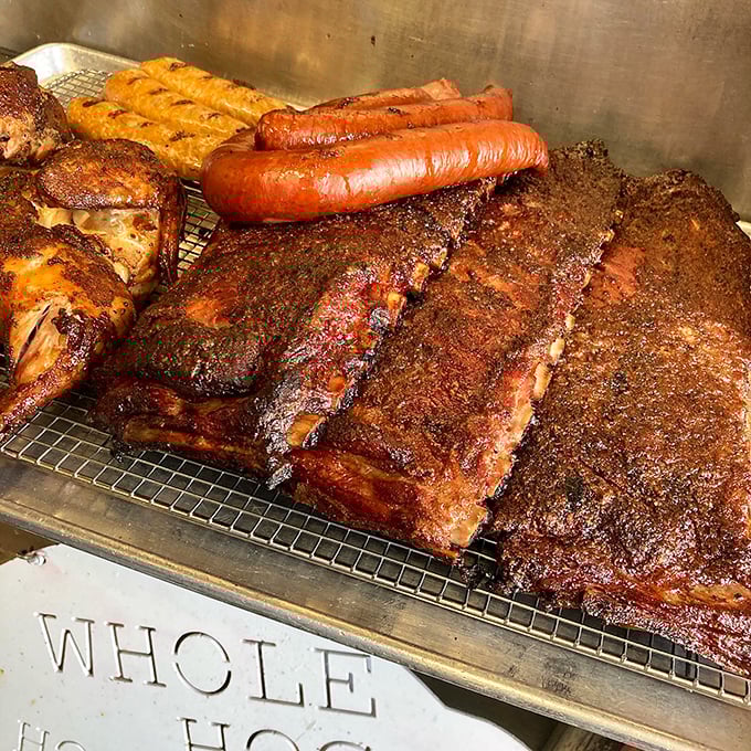 The smoker's bounty laid bare: ribs, sausage, and brisket with bark so beautiful it brings a tear to the eye of BBQ aficionados.