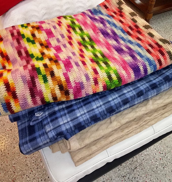 Handmade blankets with stories woven into every stitch. That colorful crocheted beauty probably took someone's grandmother months to complete.