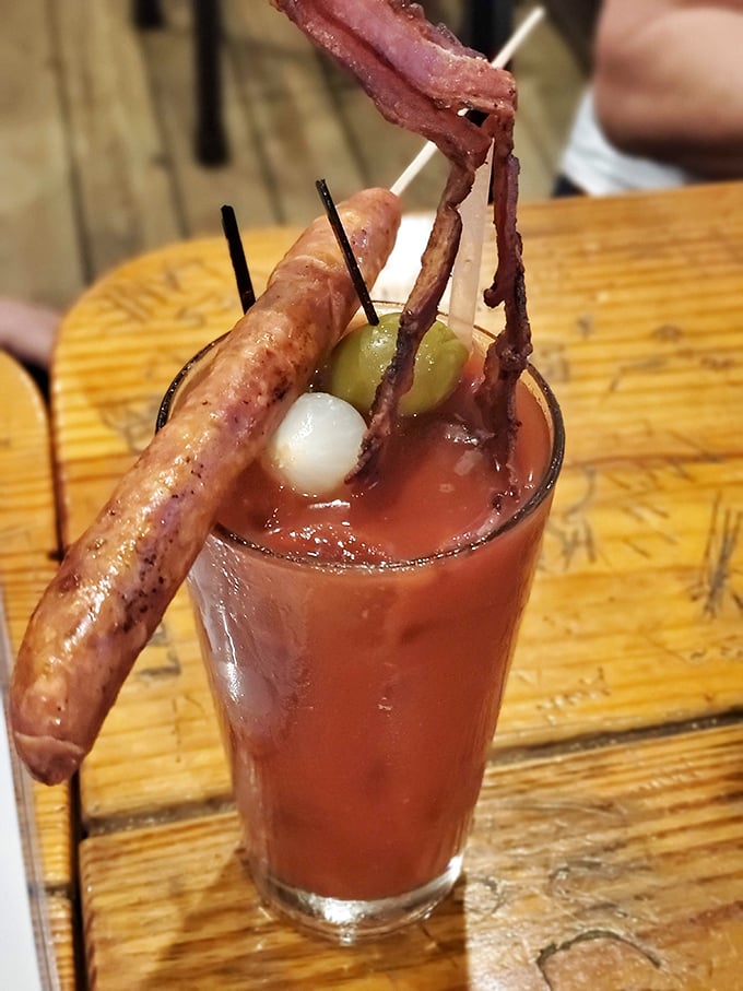 This Bloody Mary isn't just a drink—it's breakfast, lunch, and a dare all in one glass. The meat garnish alone deserves its own zip code.