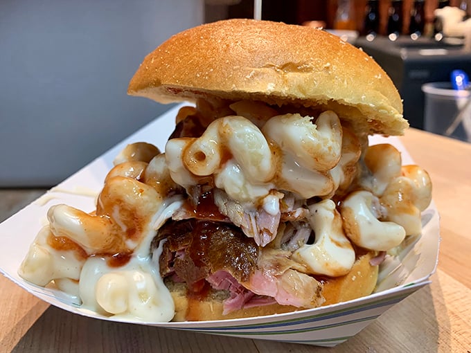 A sandwich that requires both hands and a strategy—pulled pork crowned with mac and cheese in a collaboration that borders on genius.