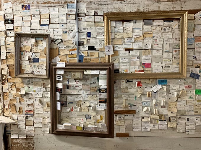 The wall of business cards tells a story of travelers from near and far, each one a testament to meals worth remembering.