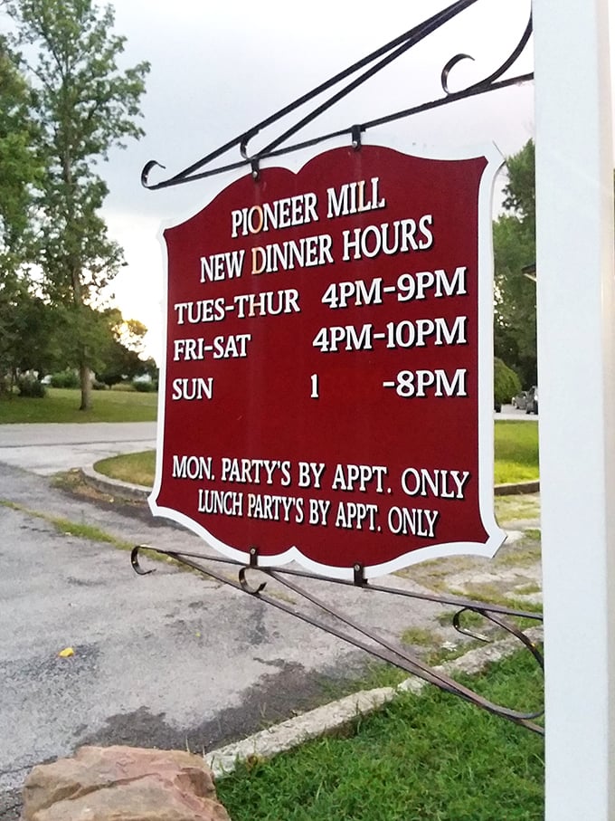 The simple red sign announces operating hours with the same straightforward honesty that defines everything about Pioneer Mill.