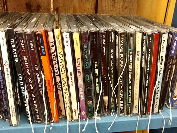 A rainbow of CD spines showcases musical history from Deb Norder to Hyde Park. Physical albums – where album art and liner notes were as important as the music.