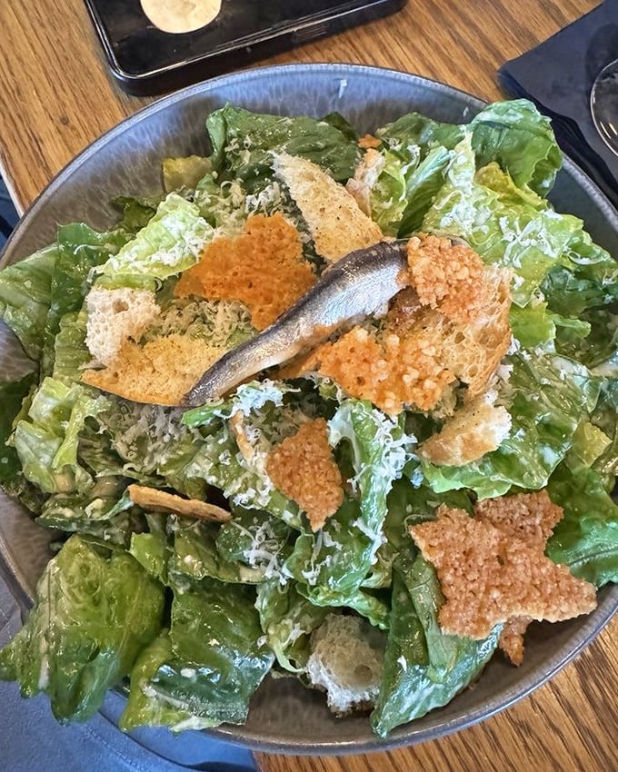 A Caesar salad that Julius himself would approve—crisp romaine, parmesan snowfall, and those gloriously crunchy croutons that shatter just right.