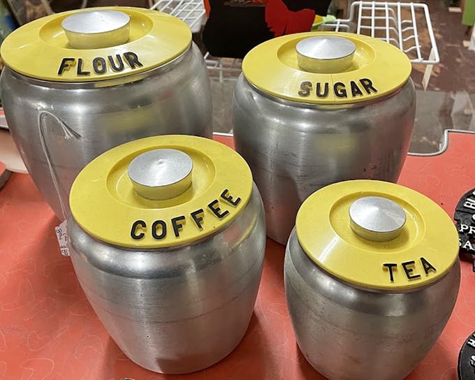 Mid-century kitchen canisters in aluminum and harvest gold—because nothing says "authentic vintage kitchen" quite like labeled sugar and flour containers.