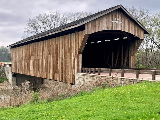 Captain Swift Covered Bridge offers a portal to simpler times, its wooden beams creating a tunnel-like passage that transforms an ordinary drive into something magical.