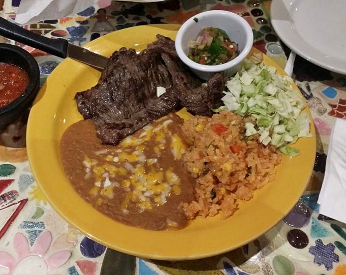 Carne asada that's been kissed by fire and blessed with spice, served with the holy trinity of Mexican sides: beans, rice, and fresh cabbage.