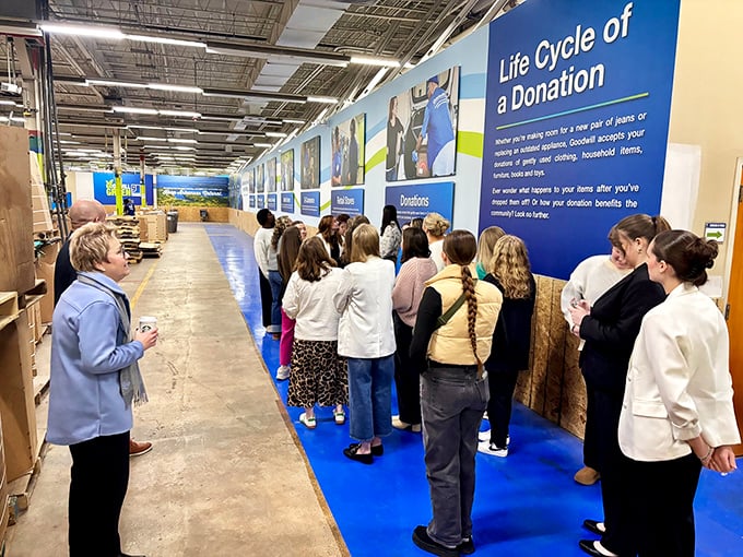 Behind the scenes—visitors learning about the lifecycle of donations and the community impact of their secondhand shopping.