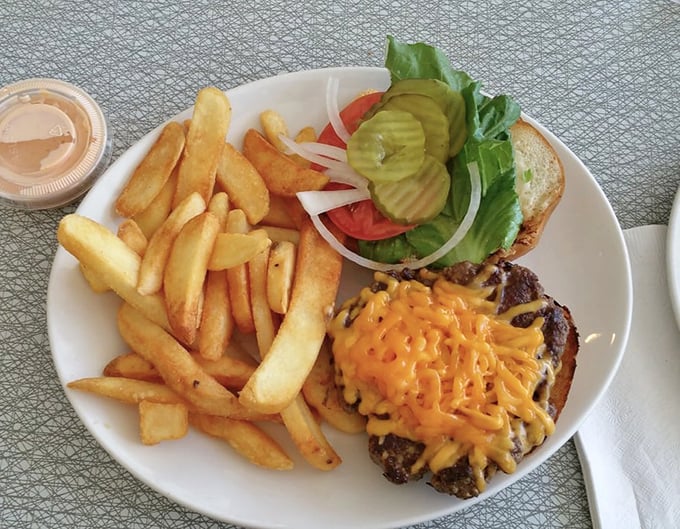 This isn't just a cheeseburger and fries—it's edible architecture where each layer contributes to a perfectly balanced bite that satisfies on a primal level.