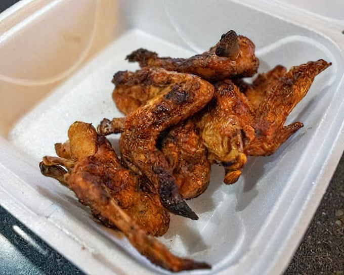 Smoked chicken wings with crispy, spice-rubbed skin—a testament that barbecue excellence extends beyond just ribs and brisket.