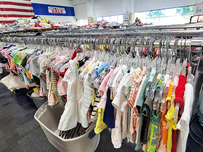 Tiny clothes in rainbow colors, ready to outfit the next generation of thrift store enthusiasts.