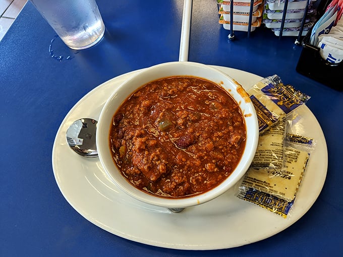A bowl of chili that doesn't mess around. This isn't some fancy chef's interpretation—it's the real deal, served with crackers for proper scooping.
