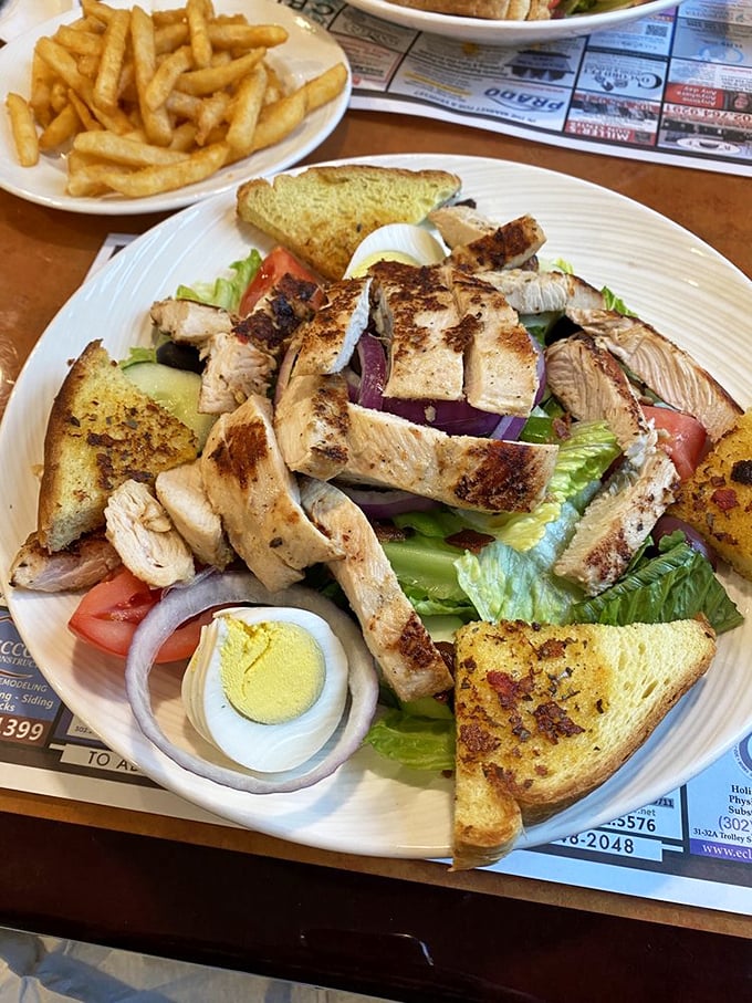 This isn't just a salad—it's a protein party where grilled chicken mingles with garden-fresh vegetables on a bed of crisp lettuce.