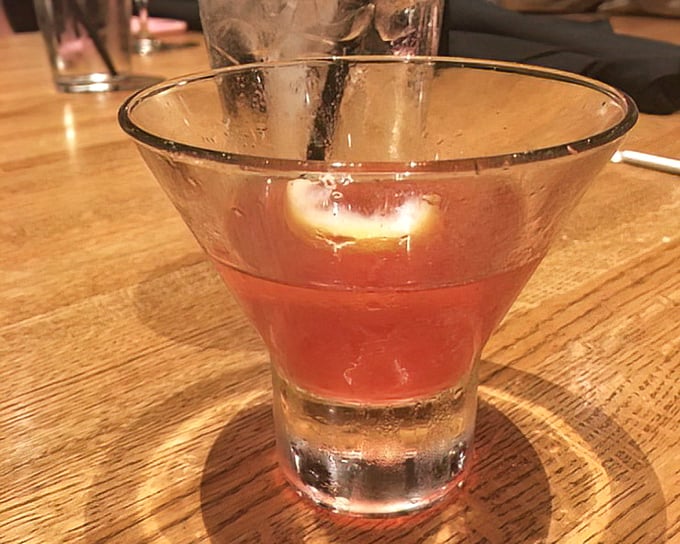 A copper-hued cocktail that catches the light just right—like liquid sunset in a glass, promising good times ahead.