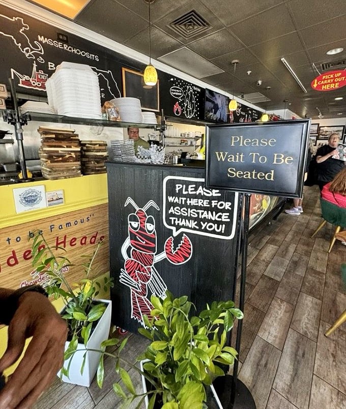 The hostess stand features a cheeky lobster cartoon – your first clue that this place takes its seafood seriously but itself, not so much.