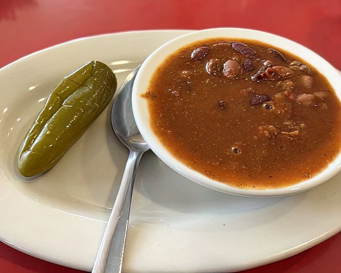 A bowl of homemade chili with that pickle companion—comfort food that's been warming Knoxville souls through decades of Tennessee winters.