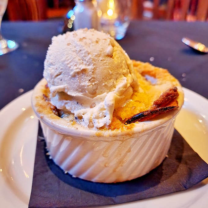 A crème brûlée with a perfectly torched top that crackles like autumn leaves. The ice cream melts slowly, creating a sweet symphony in every spoonful.