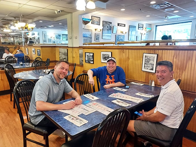 Happy diners plotting their strategic approach to the menu – notice the look of both determination and joy in their pre-sandwich planning session.