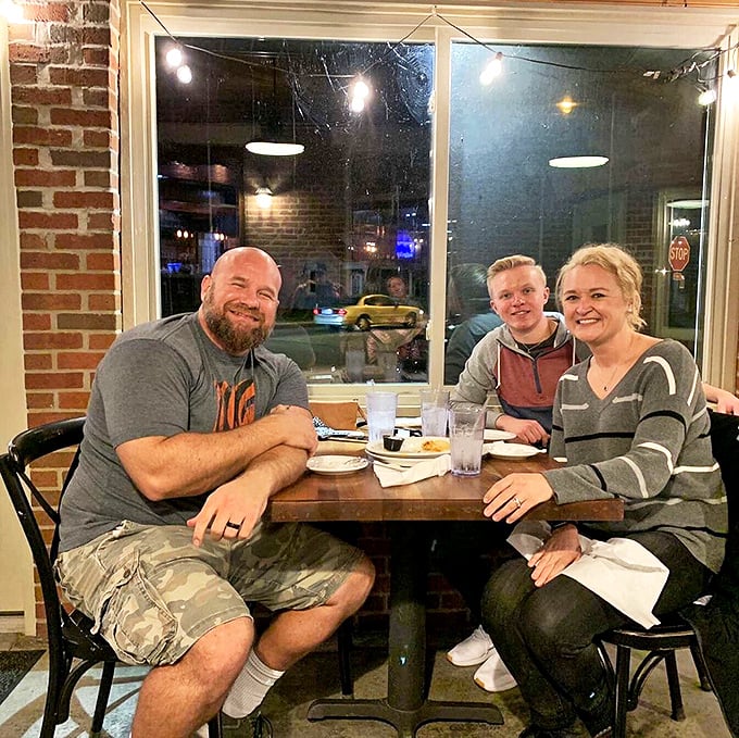 Happy diners by the window—living proof that good barbecue creates its own special kind of contentment that's impossible to fake.