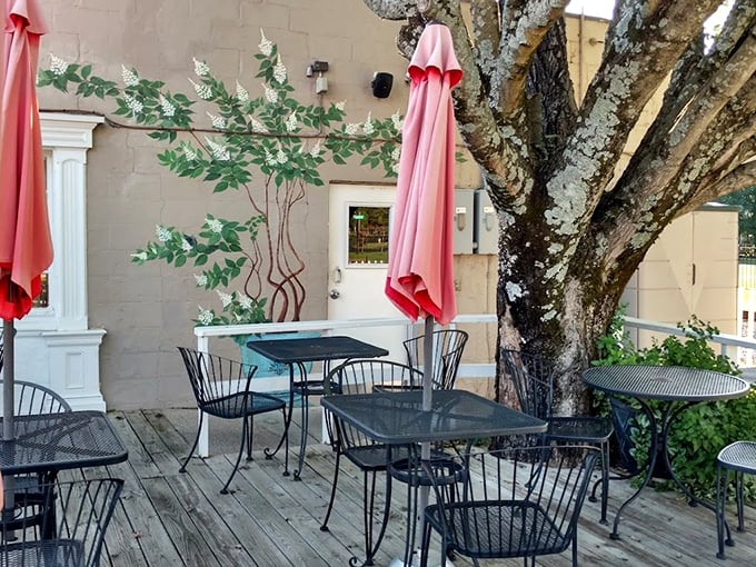 The outdoor patio offers al fresco dining under pink umbrellas and a magnificent old tree. Southern summers were made for evenings like this.