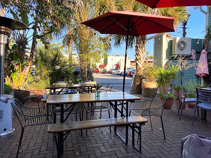 Outdoor dining surrounded by palms and potted plants—nature's way of saying, "Take your time, the office emails can wait."