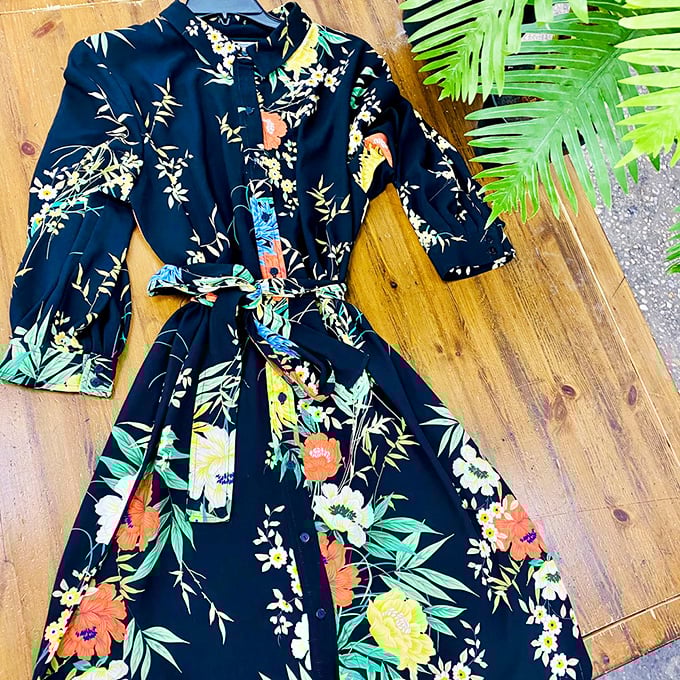 A floral dress that whispers "garden party elegance" without shouting "I emptied my wallet." Thrift store magic at its finest.