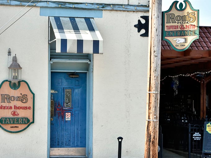 The blue door entrance to Ron's Tavern side hints at the establishment's dual personality—part family pizza joint, part neighborhood watering hole.