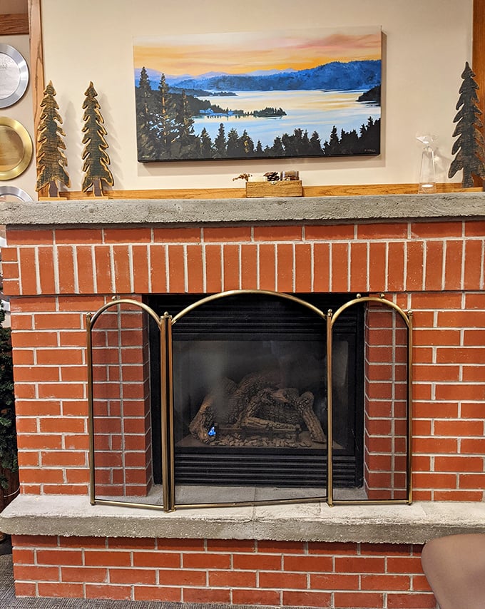 The brick fireplace adds a touch of mountain lodge charm, with artwork celebrating the natural beauty that makes Idaho so special.