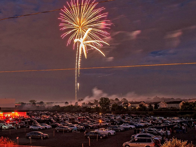 Independence Day celebrations reach new heights with fireworks bursting over parked cars—dinner, a movie, and a light show for one ticket price.