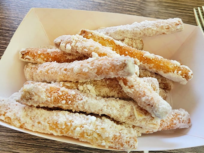 Funnel cake fries—because someone brilliant realized carnival joy shouldn't be limited to annual events. That powdered sugar dusting is pure nostalgia.