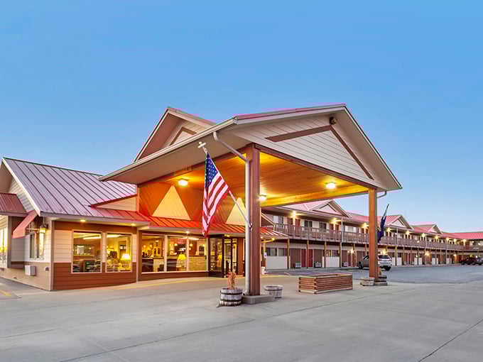 Harmony Inn & Suites glows with warm light at dusk, promising weary travelers the two things they want most: comfort and no surprises.