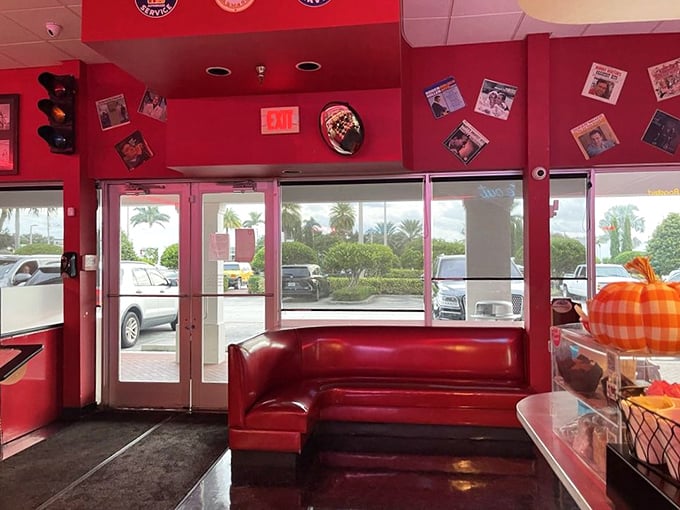 The entrance doesn't just welcome you—it embraces you with that signature red vinyl, promising comfort before you've even ordered your first cup of coffee.