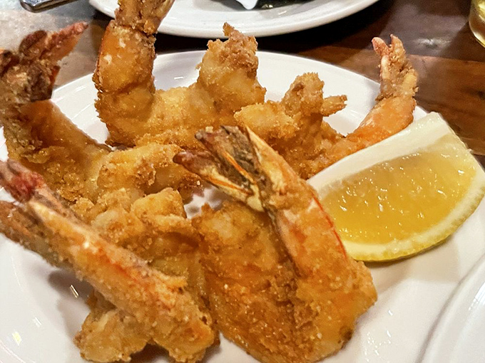 These jumbo fried prawns aren't messing around—golden-battered crustaceans that snap with freshness and beg for a dunk in that lemon wedge.