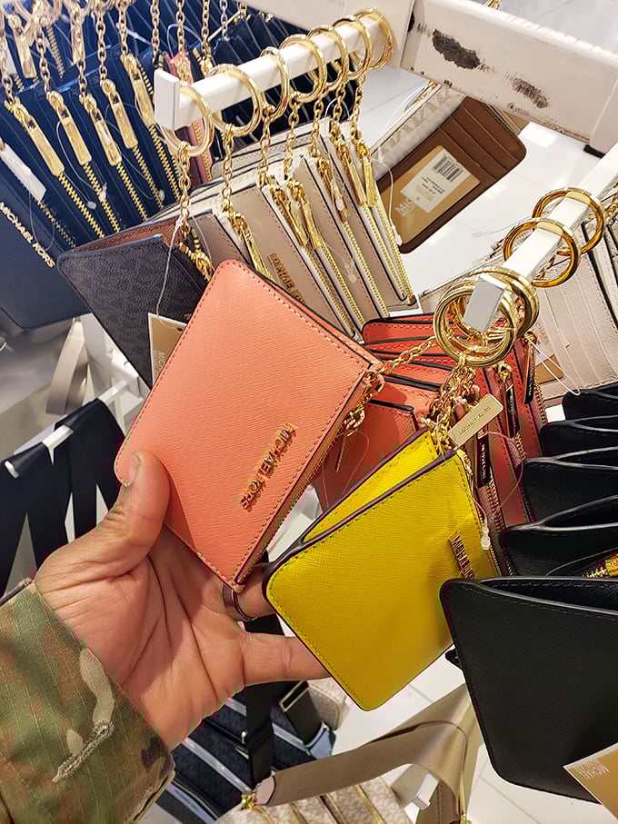 Michael Kors key fobs and coin purses—the gateway purchases to designer addiction. That coral shade isn't just a color—it's an investment in your handbag future.