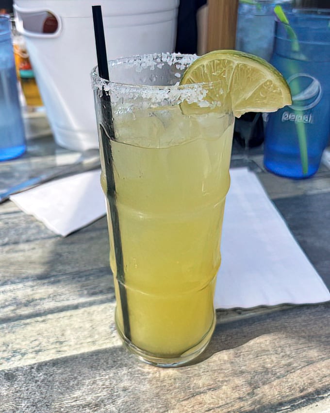 Their margarita arrives with a salt-crusted rim and lime wedge standing guard—a refreshing companion to cut through the richness of fried seafood delights.