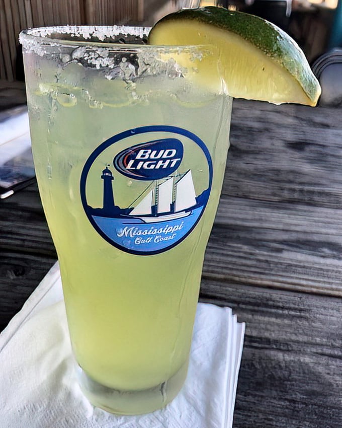 This isn't just a margarita – it's coastal refreshment in a glass. That salt rim and lime wedge promise to wash away your worries.