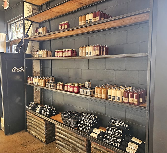Truth's merchandise wall isn't just about branded t-shirts—it's a shrine to house-made sauces and rubs that let you attempt barbecue magic at home.