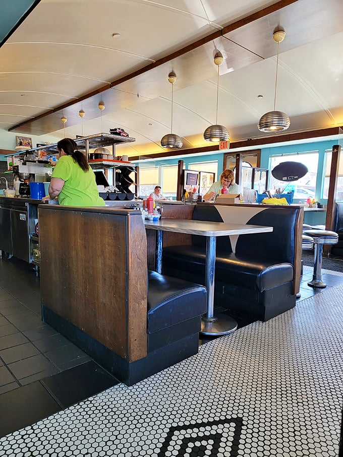 The heart of any great diner is its bustling kitchen area. Those pendant lights aren't just illuminating the space—they're spotlighting culinary magic in progress.