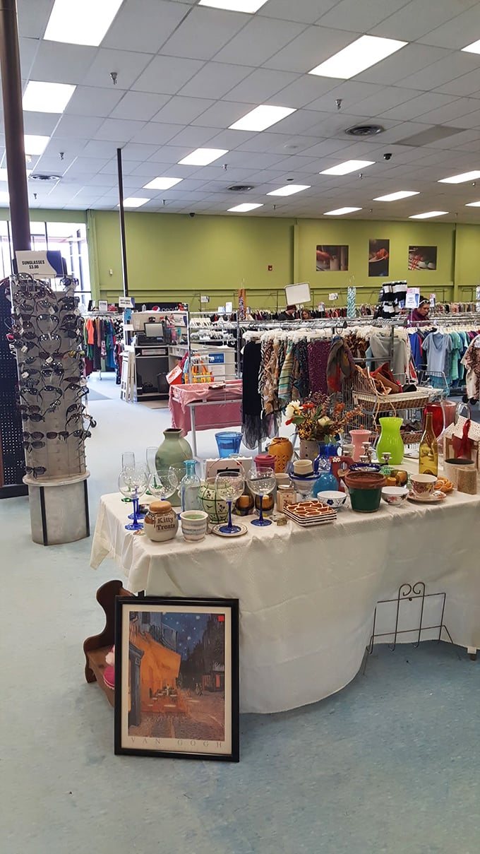 Glassware, knickknacks, and framed art create an impromptu still life—a curated chaos that somehow makes perfect sense in the thrift store universe.