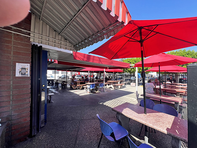 Red umbrellas and picnic tables under California sky—outdoor dining doesn't need to be fancy to be perfect.
