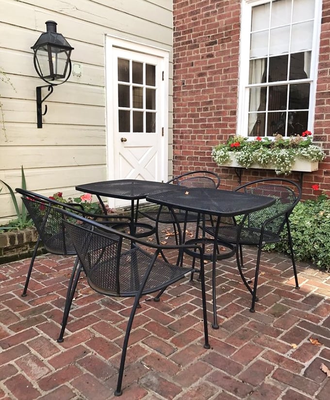 Outdoor dining with brick pathways and flower boxes – suburban paradise meets colonial charm.