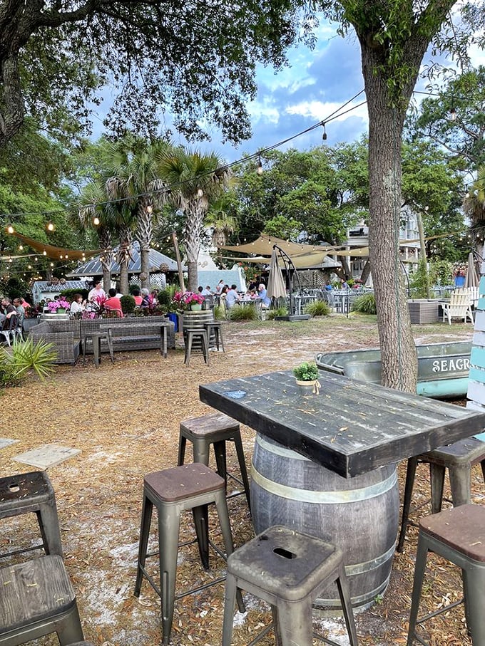 String lights twinkle above outdoor tables nestled among palm trees. Florida dining as it should be—casual, breezy, and surrounded by nature.