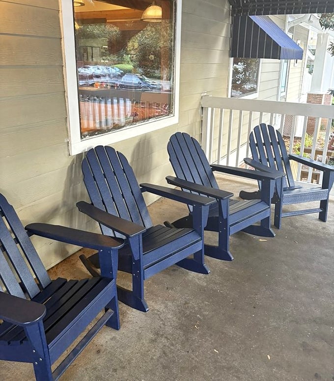 Blue Adirondack chairs on the porch offer a perfect waiting spot. The best things in life are worth sitting for.